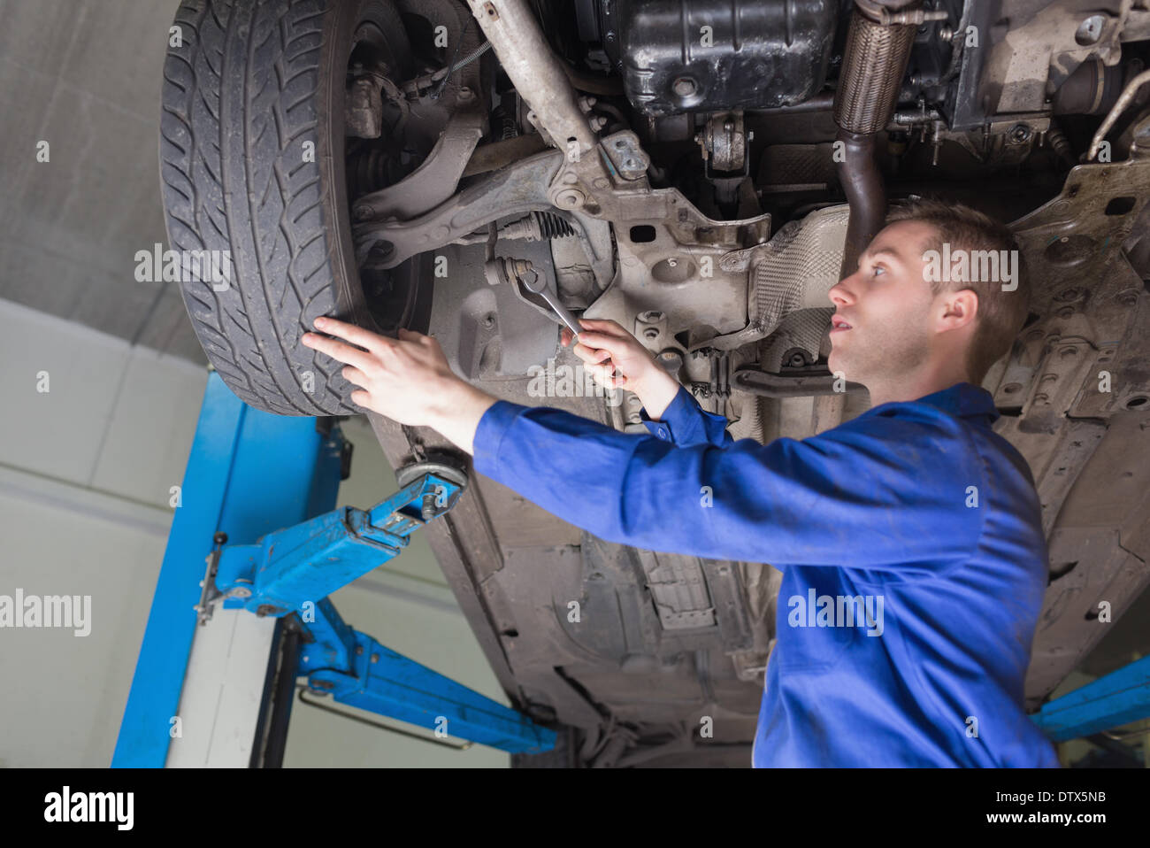 Mechanic standing repairing below hi-res stock photography and images ...