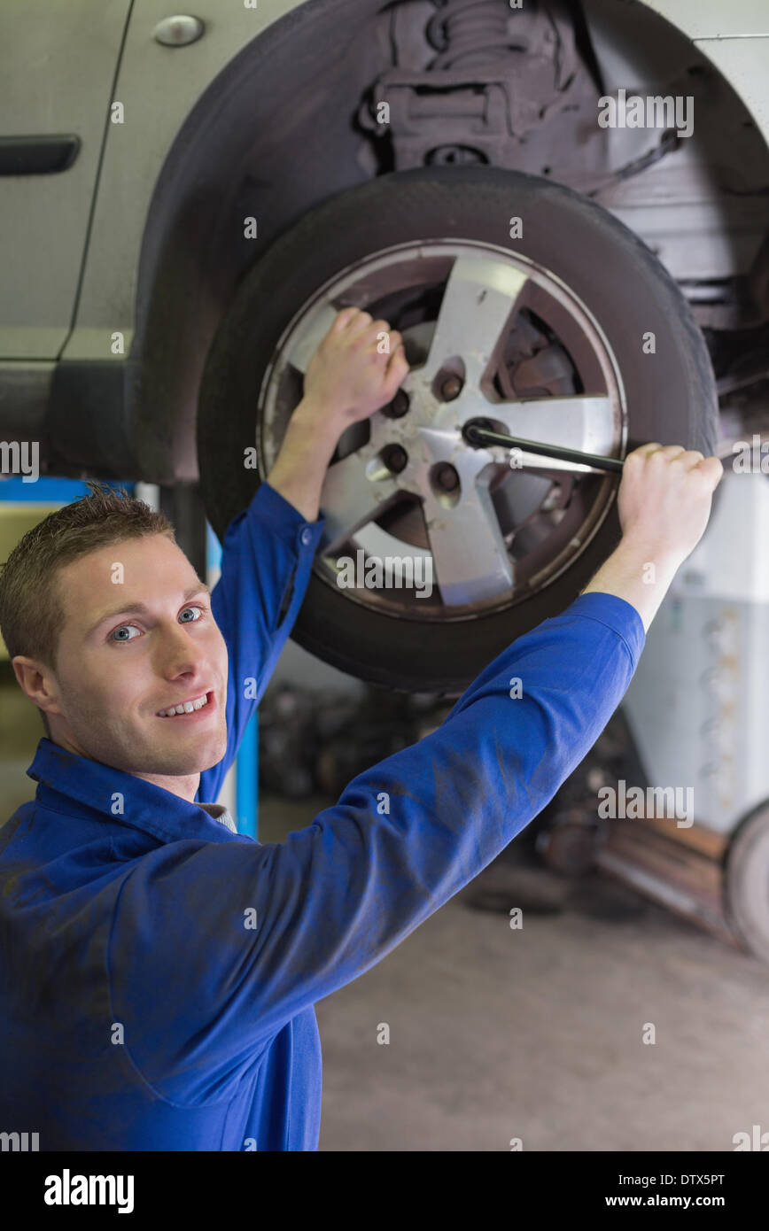 Mechanic tightening tire hi-res stock photography and images - Alamy