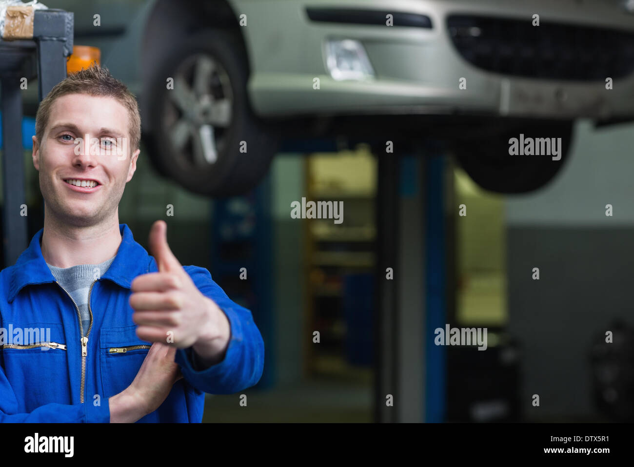 Auto mechanic gesturing thumbs up Stock Photo - Alamy