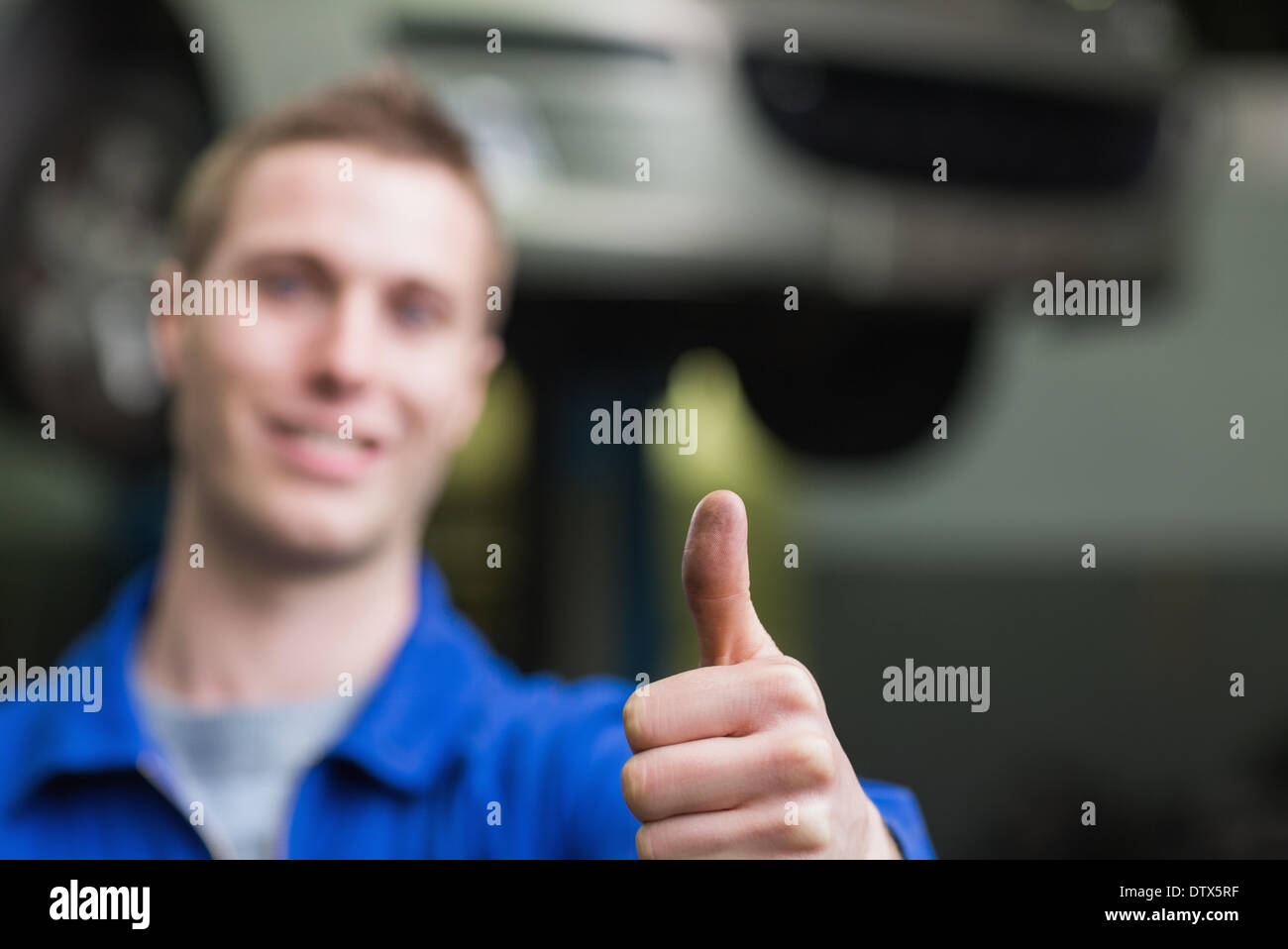 Auto mechanic gesturing thumbs up Stock Photo - Alamy