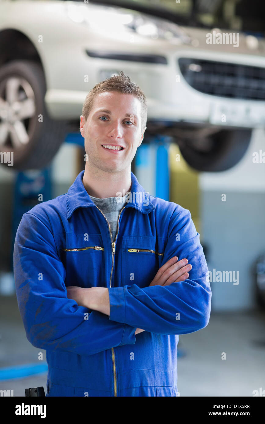 Confident male mechanic smiling Stock Photo - Alamy