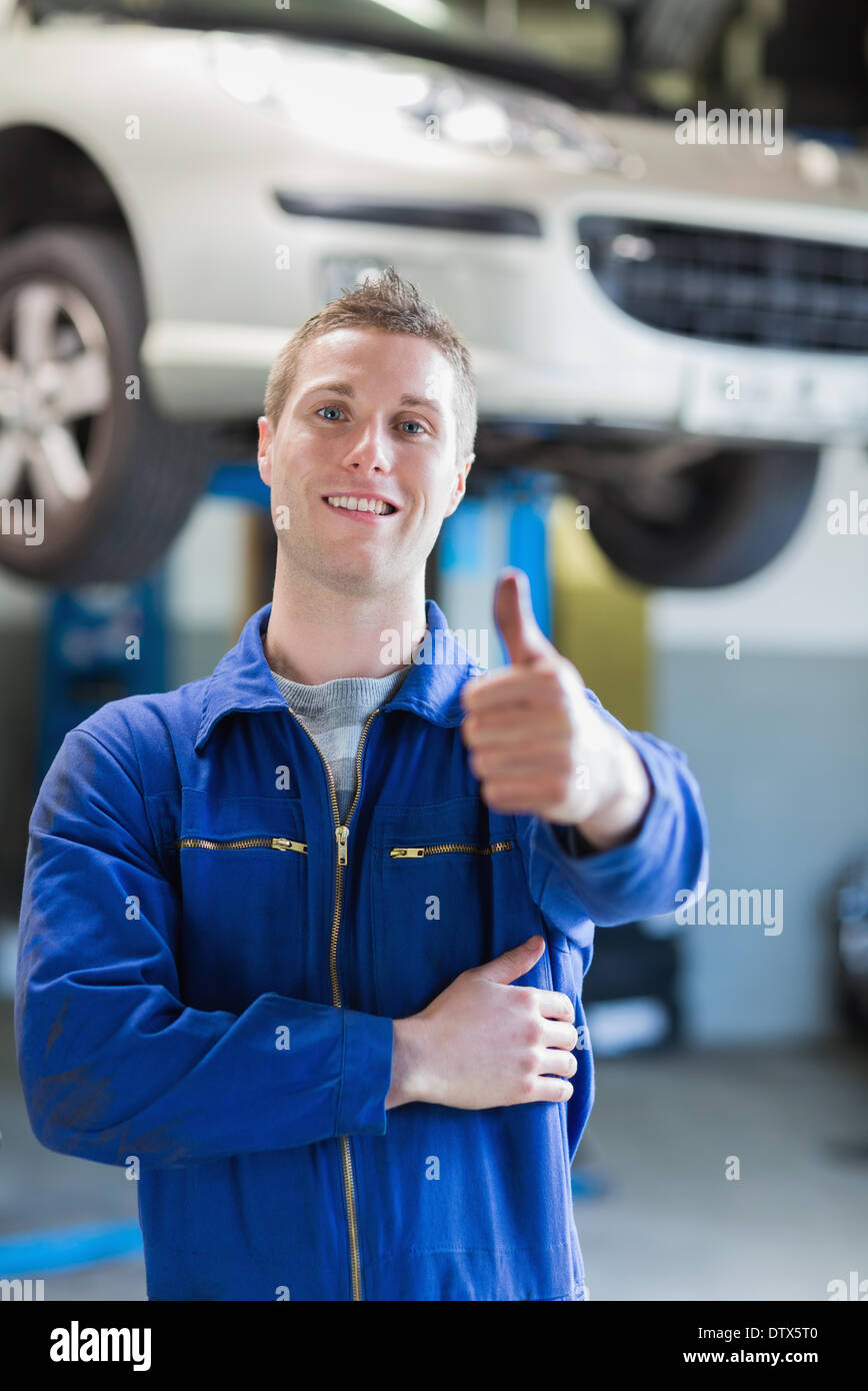 Happy male mechanic gesturing thumbs up Stock Photo - Alamy
