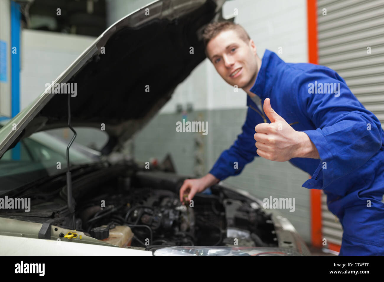 Mechanic gesturing thumbs up Stock Photo - Alamy