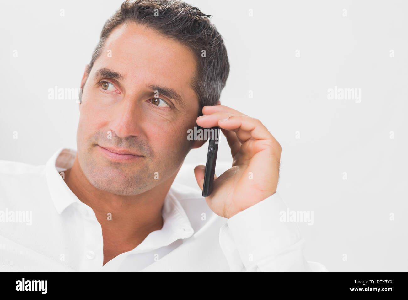 Man phoning and looking away Stock Photo - Alamy