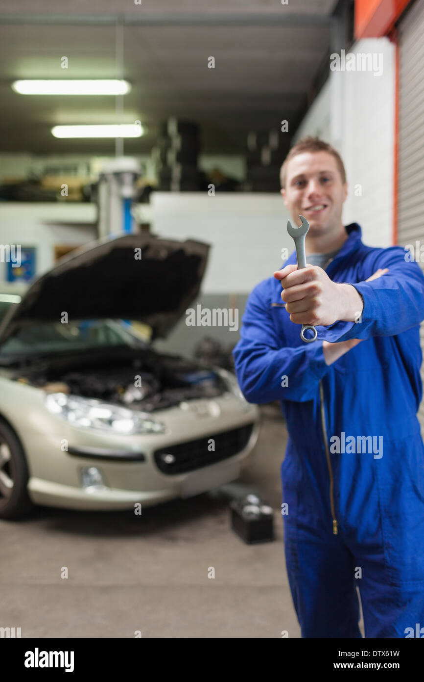 Male mechanic showing spanner Stock Photo - Alamy