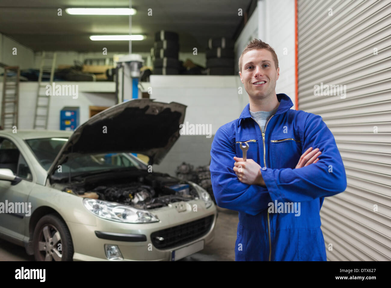 Confident male mechanic with spanner Stock Photo - Alamy
