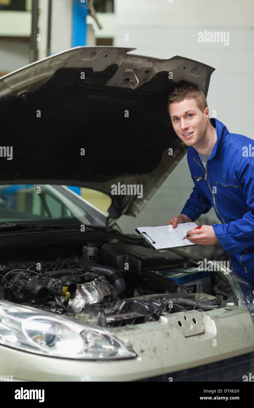 Auto mechanic inspecting car Stock Photo - Alamy