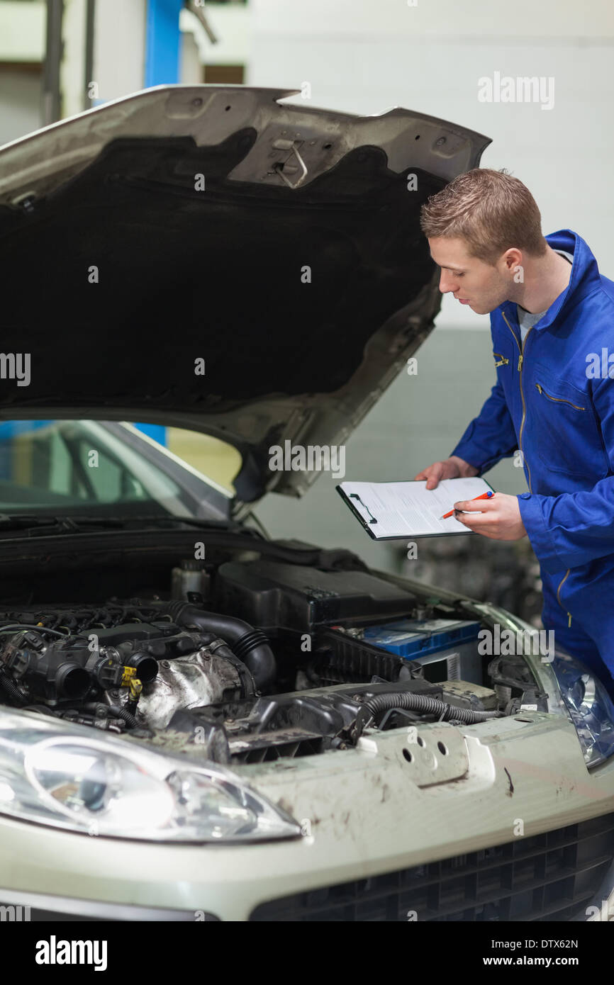 Mechanic checking car engine Stock Photo - Alamy