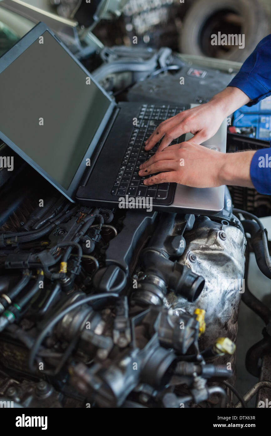 Car mechanic using laptop Stock Photo - Alamy
