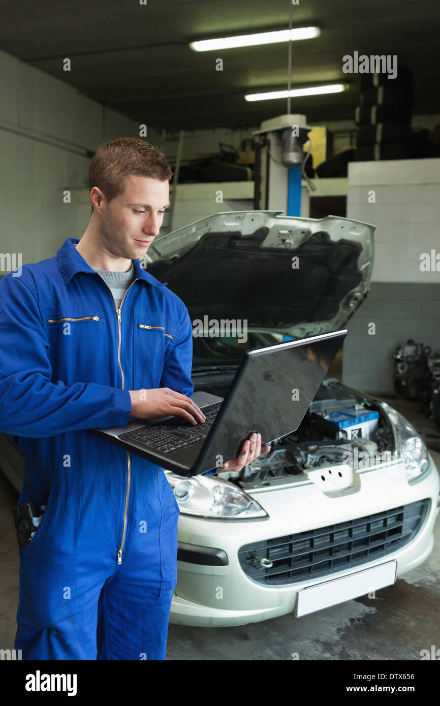 Mechanic using laptop Stock Photo - Alamy