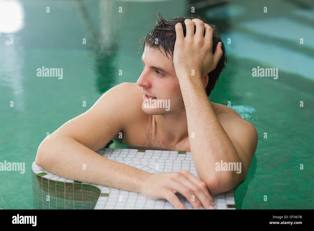 Man relaxing in swimming pool Stock Photo - Alamy