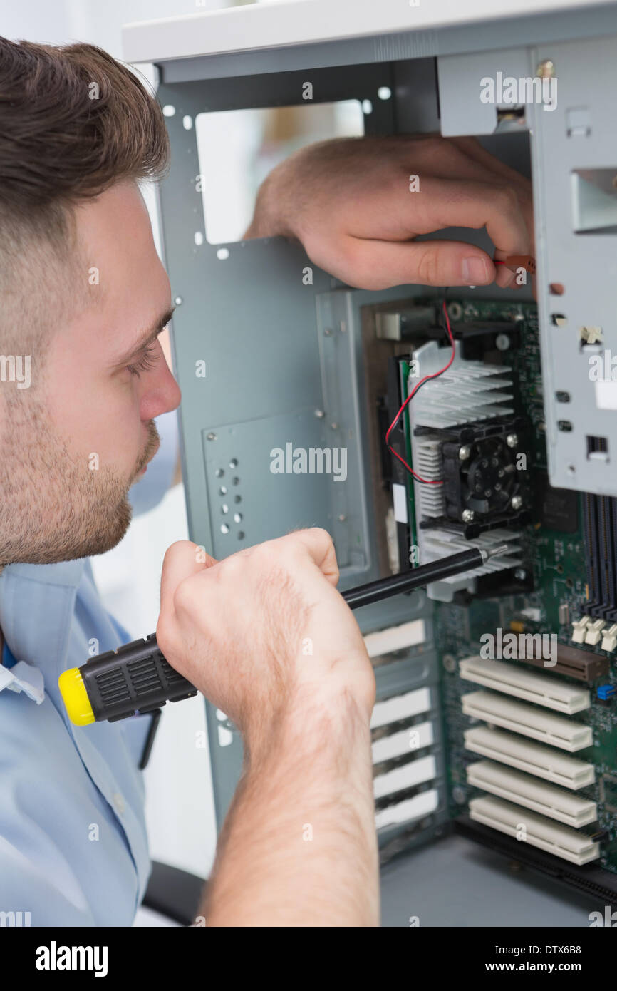 Young it professional fixing computer problem Stock Photo - Alamy