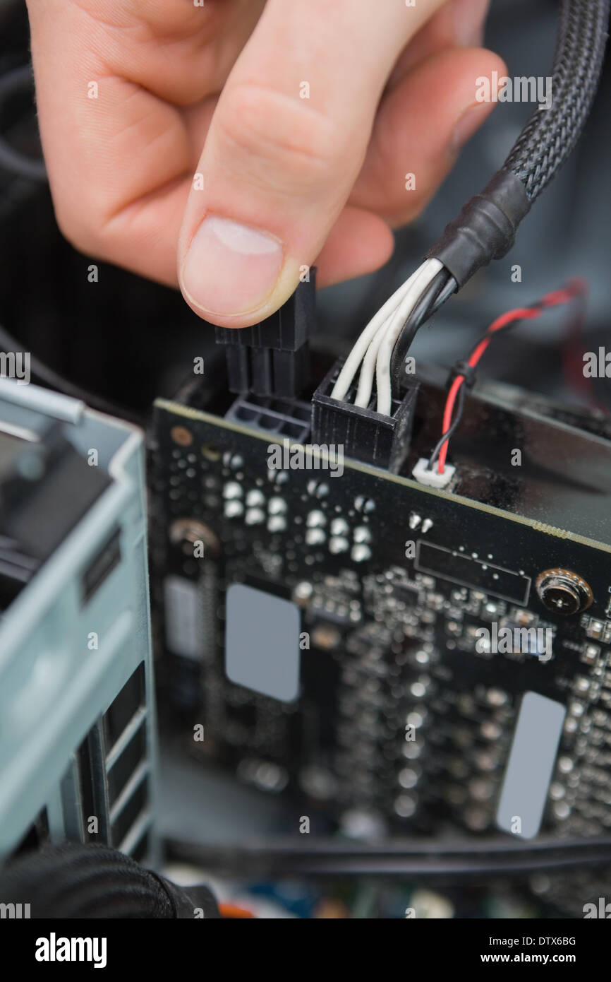 Hand fixing motherboard Stock Photo - Alamy