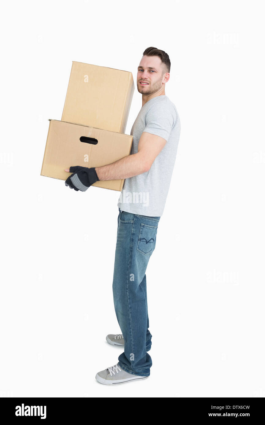 Portrait of young man carrying package boxes Stock Photo - Alamy