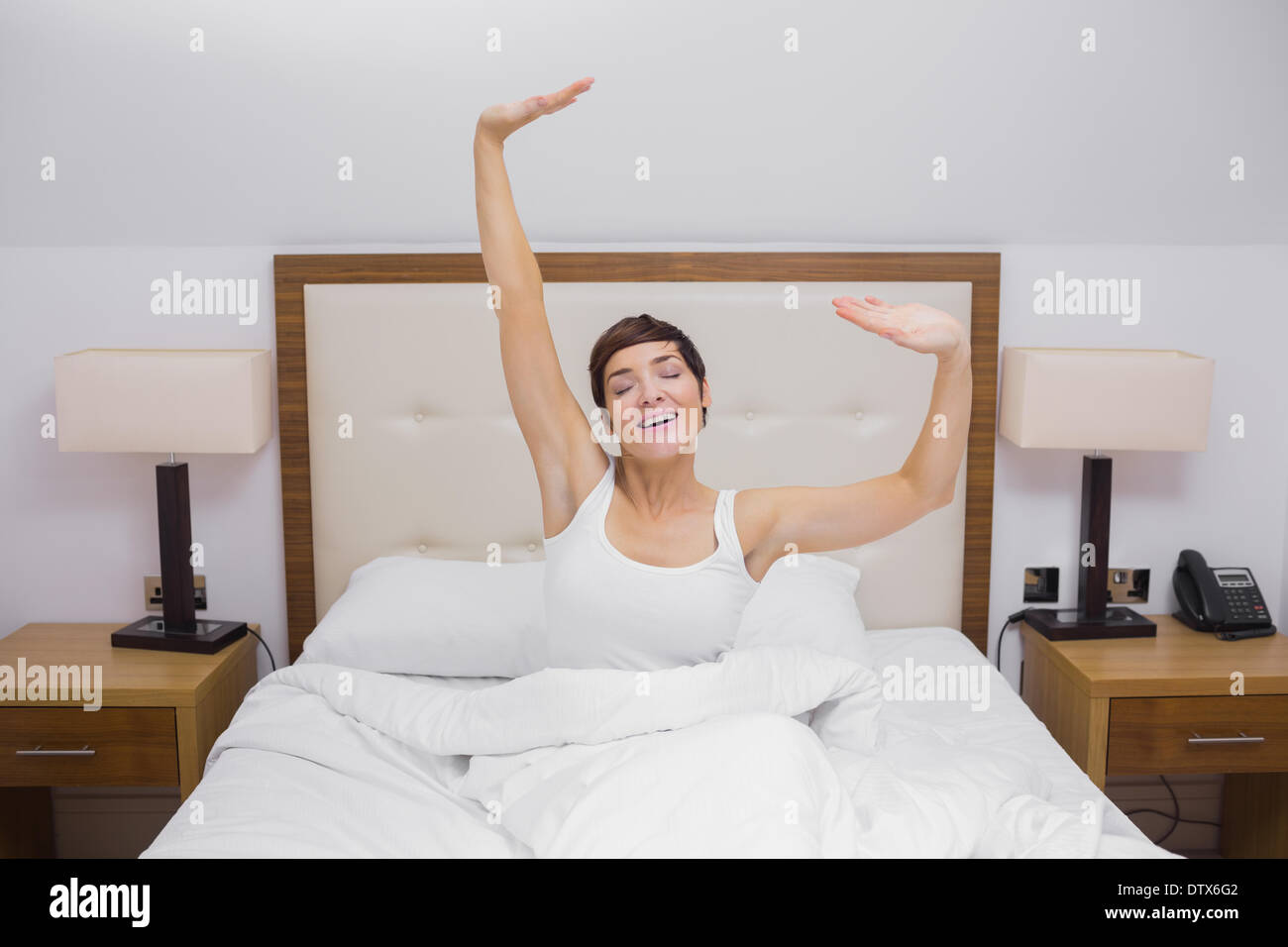Pretty girl stretching in bed Stock Photo - Alamy
