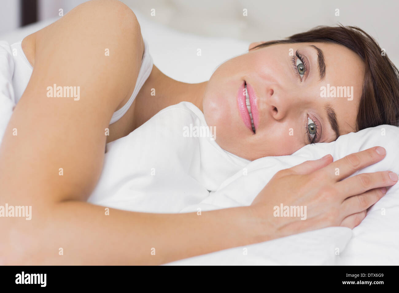 Female smiling in bed Stock Photo - Alamy