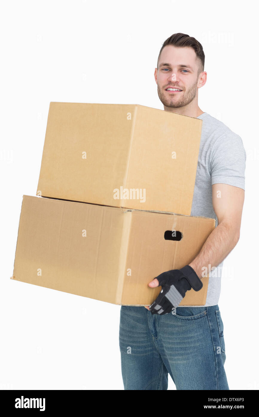 Portrait of young man carrying package boxes Stock Photo - Alamy
