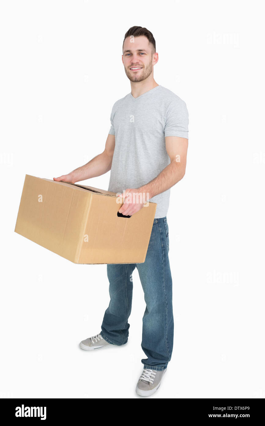Portrait of young man carrying cardboard box Stock Photo - Alamy