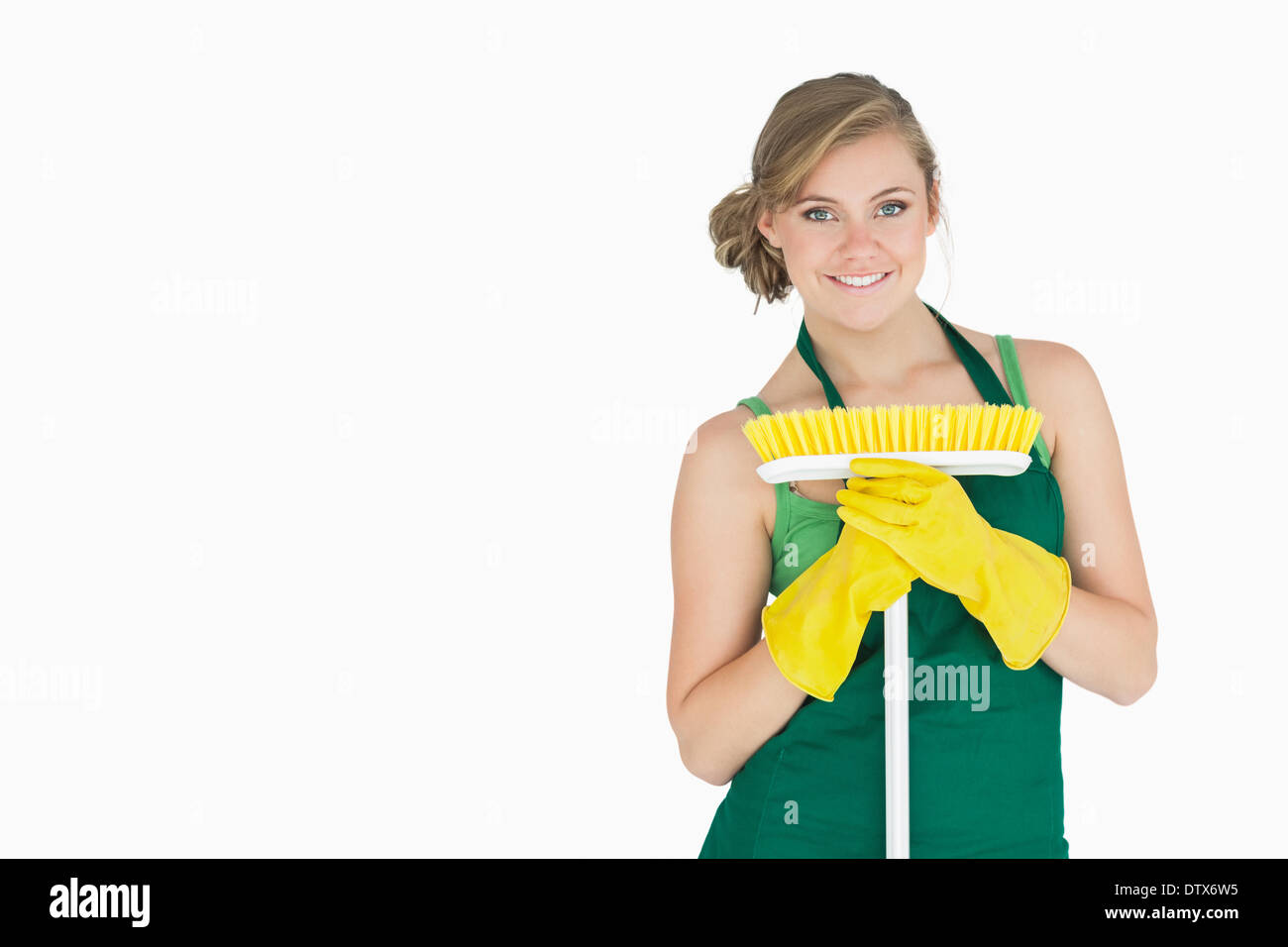 Portrait of young woman with broom Stock Photo - Alamy