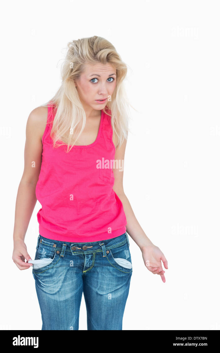 Sad young female showing her empty pockets Stock Photo - Alamy