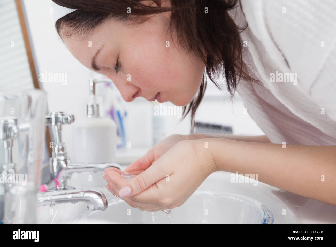 Young woman washing face Stock Photo - Alamy