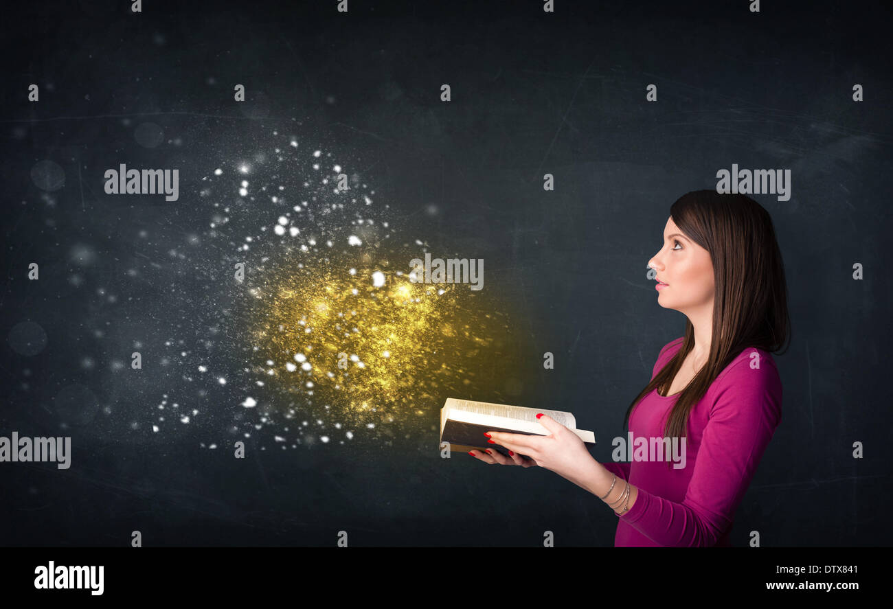 Young lady reading a magical book Stock Photo - Alamy