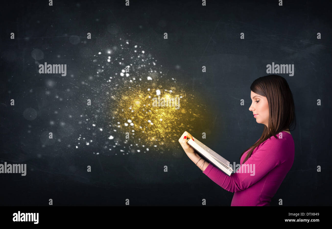 Young lady reading a magical book Stock Photo - Alamy