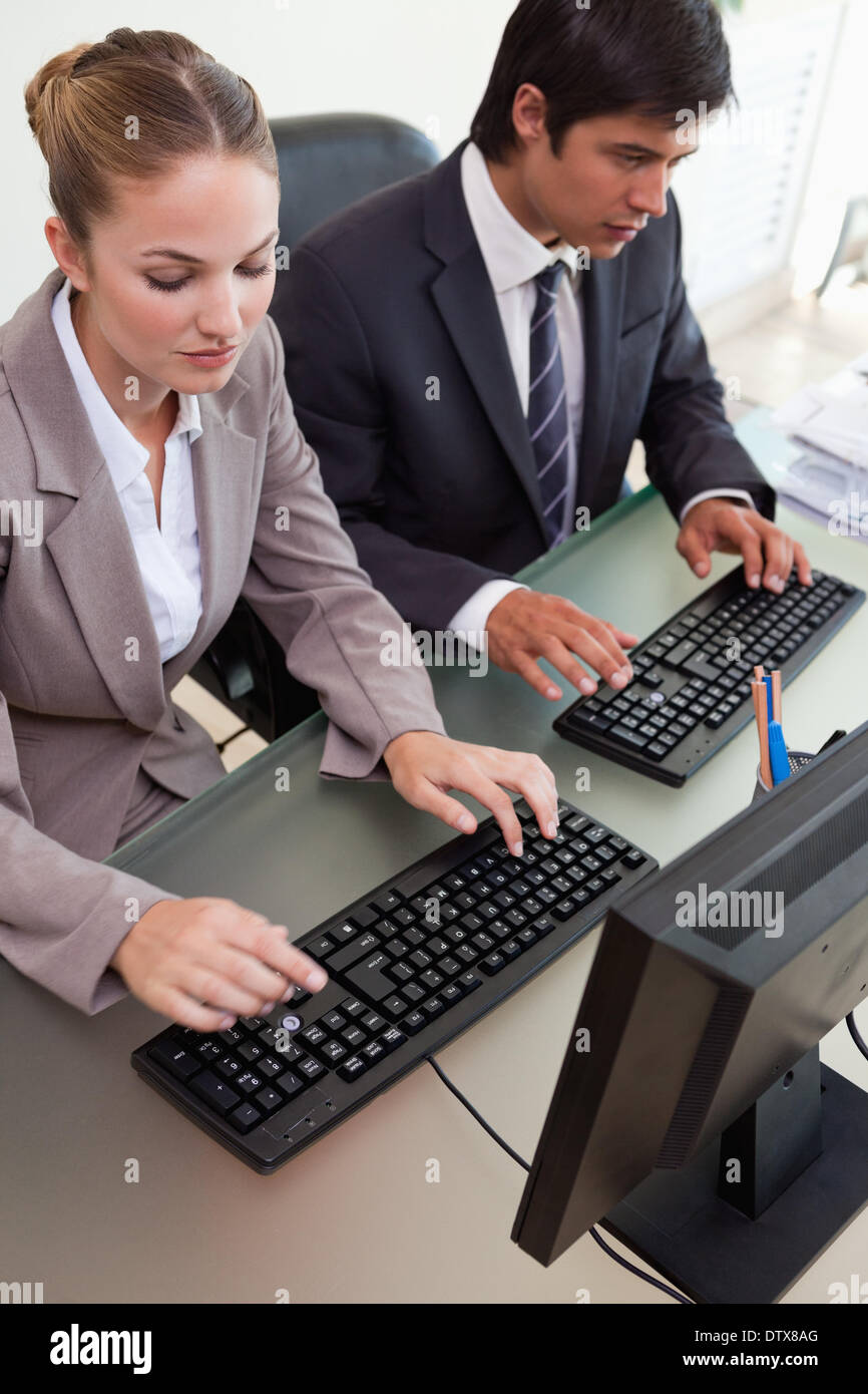 Business colleagues using computers in office Stock Photo - Alamy
