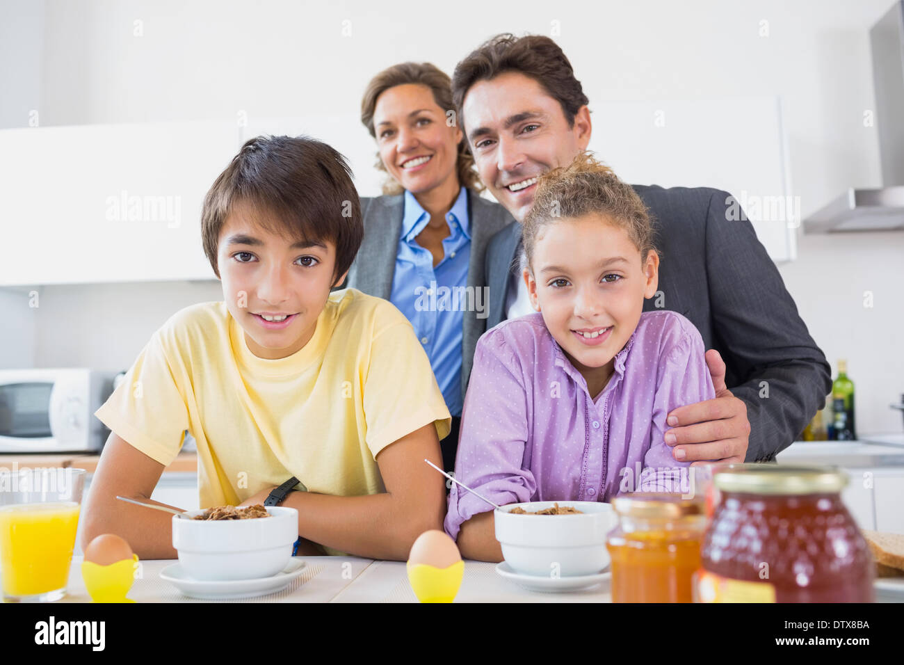 Happy family having breakfast together Stock Photo - Alamy