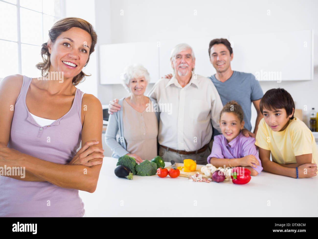 Mother standing by kitchen counter Stock Photo - Alamy