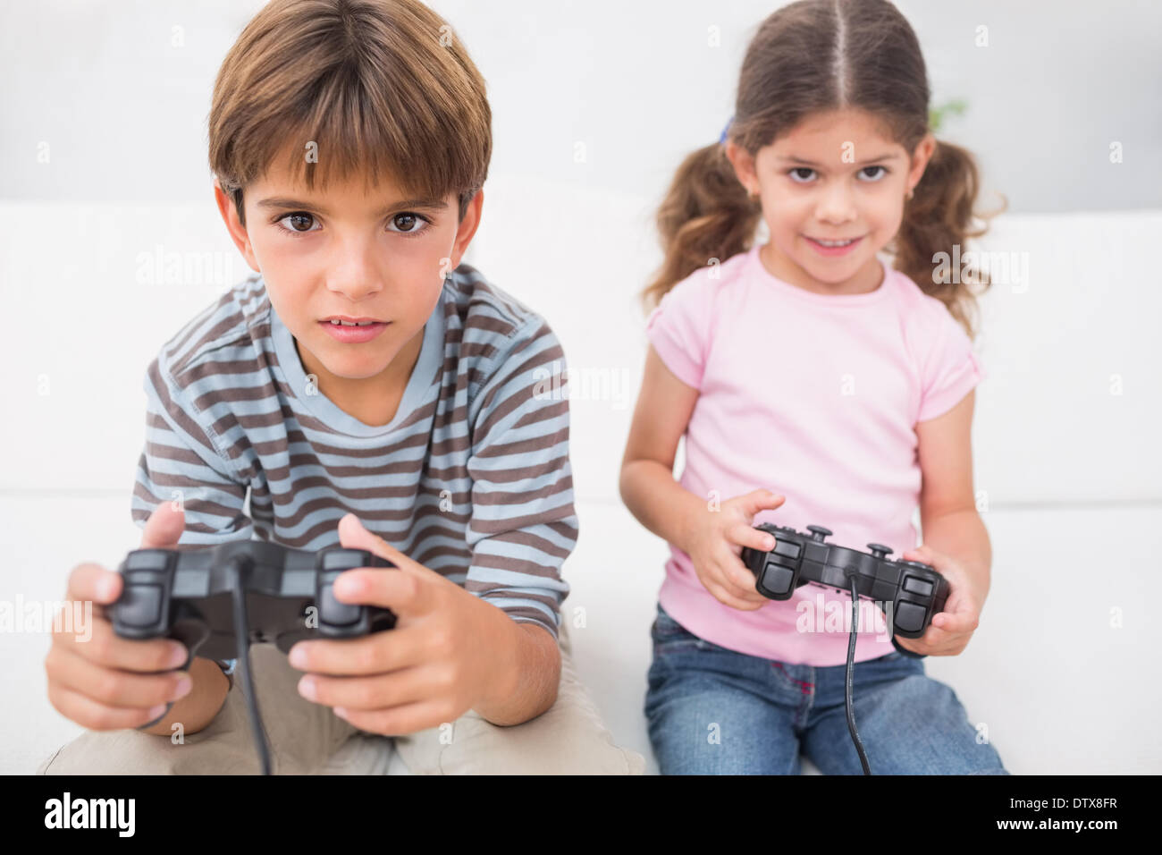 Brother and sister playing video games Stock Photo - Alamy
