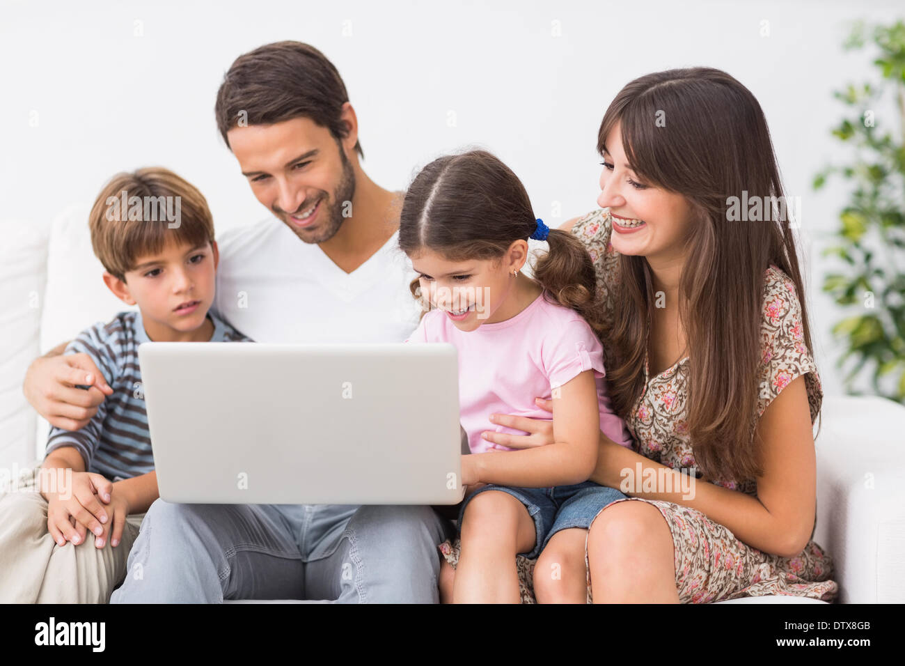 Family using laptop together Stock Photo - Alamy