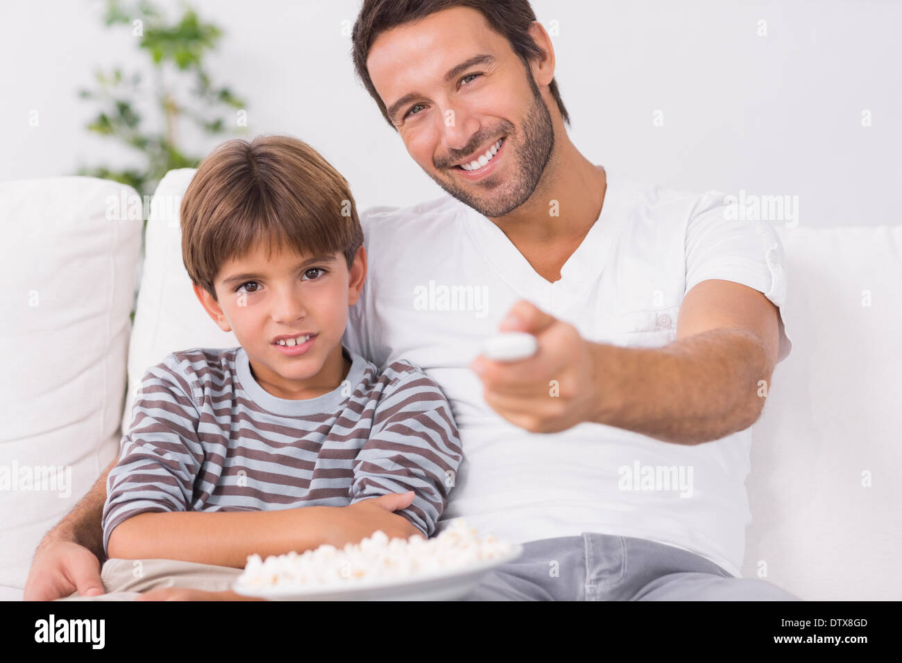 Father and son watching television Stock Photo - Alamy