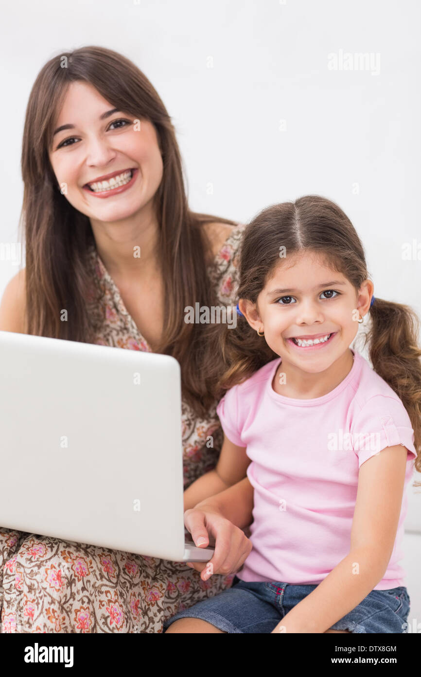 Mother and daughter happily using laptop Stock Photo - Alamy