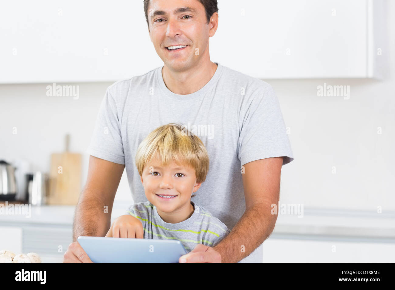 Happy father son using tablet hi-res stock photography and images - Alamy
