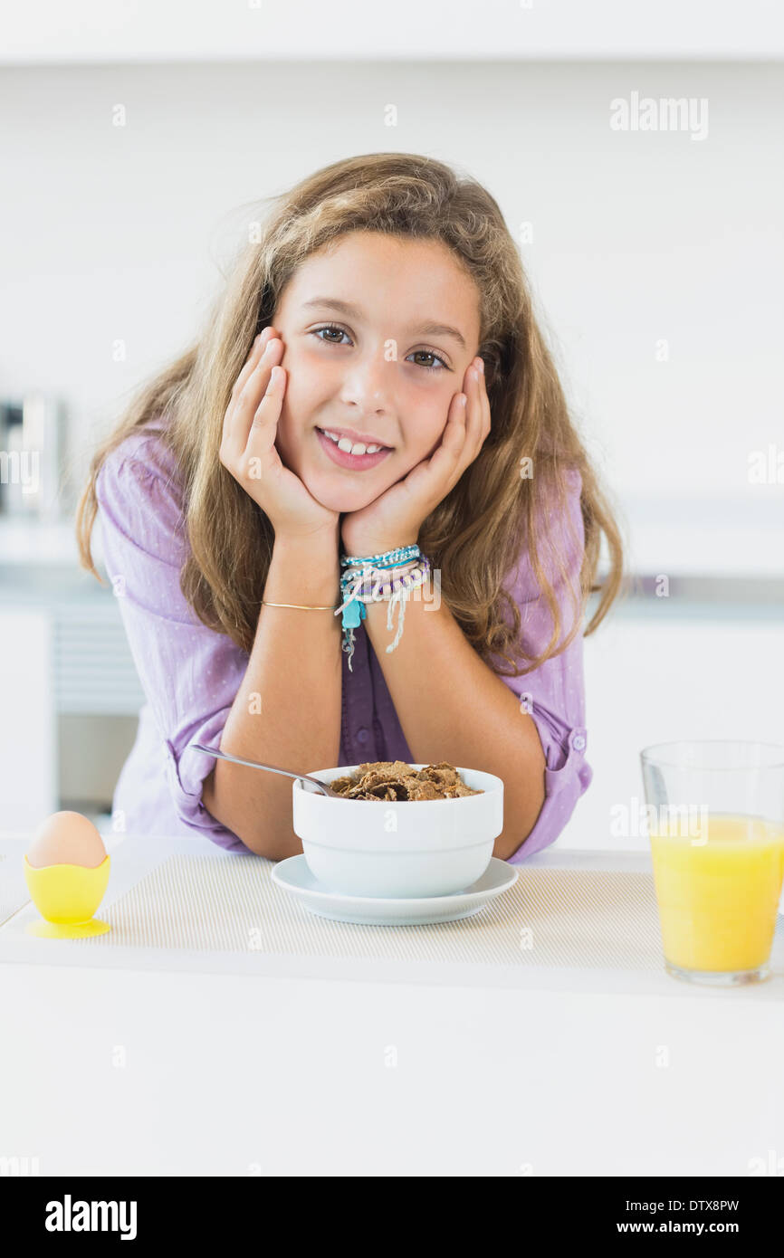 Happy girl at breakfast Stock Photo - Alamy