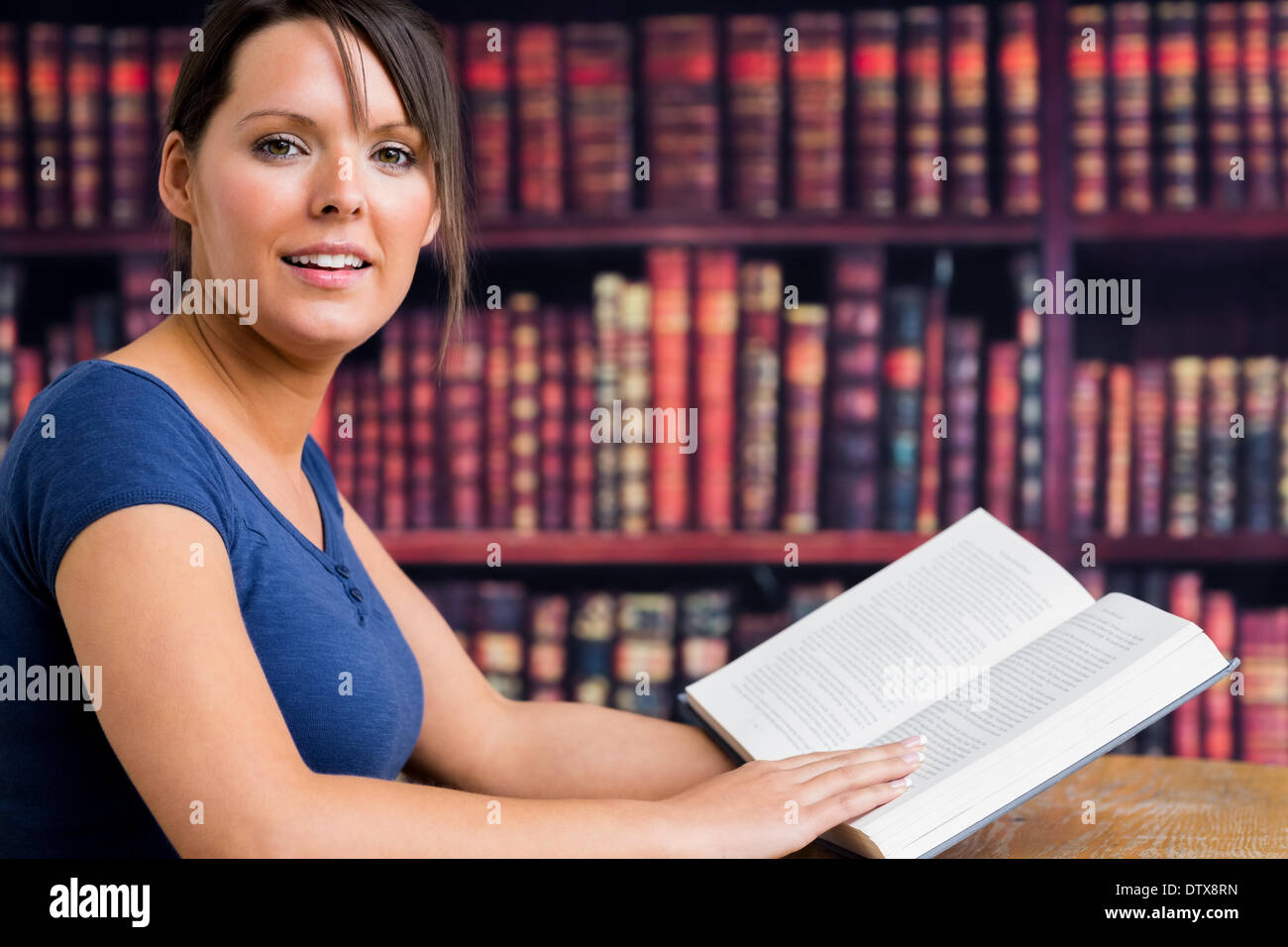 Girl smiling with book Stock Photo - Alamy