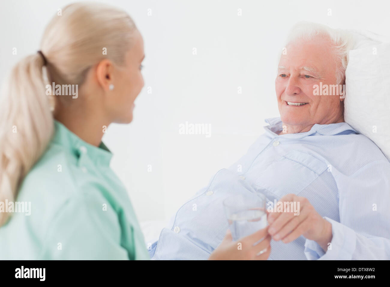 Young man and woman giving water hi-res stock photography and images ...