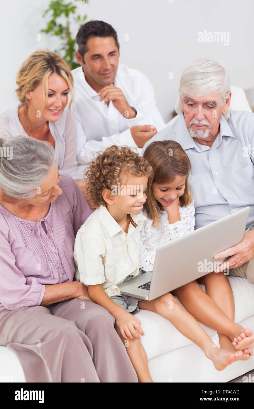 Extended family watching laptop Stock Photo - Alamy
