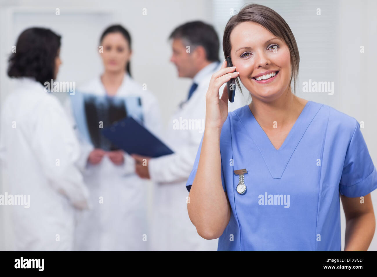 Nurse calling with her team Stock Photo - Alamy