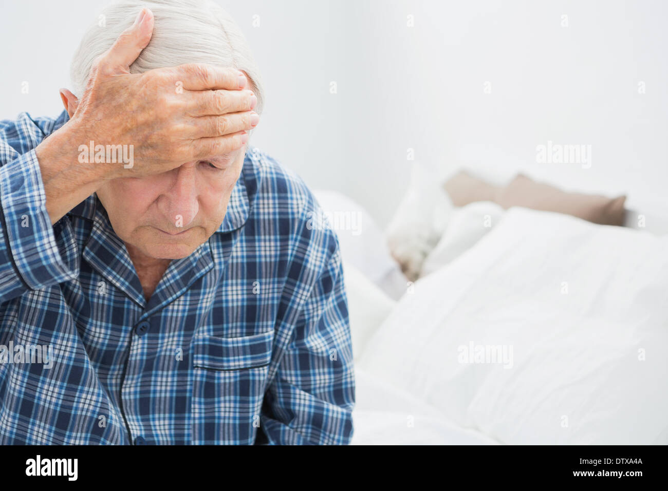 Elderly man suffering on the bed Stock Photo - Alamy