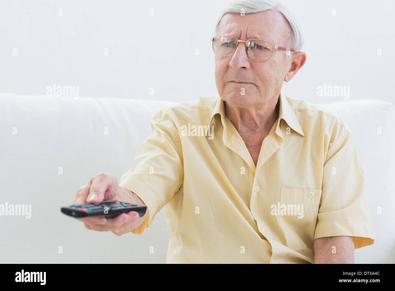 Elderly man holding remote hi-res stock photography and images - Alamy