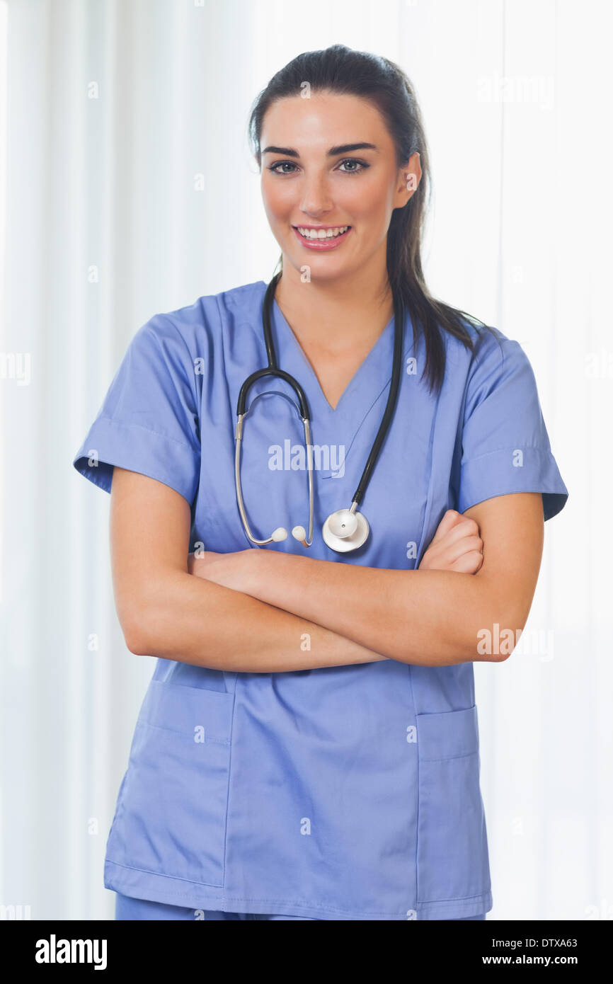 Smiling nurse with arms crossed Stock Photo - Alamy