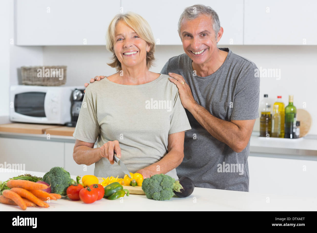 Happy couple cutting vegetables together Stock Photo - Alamy