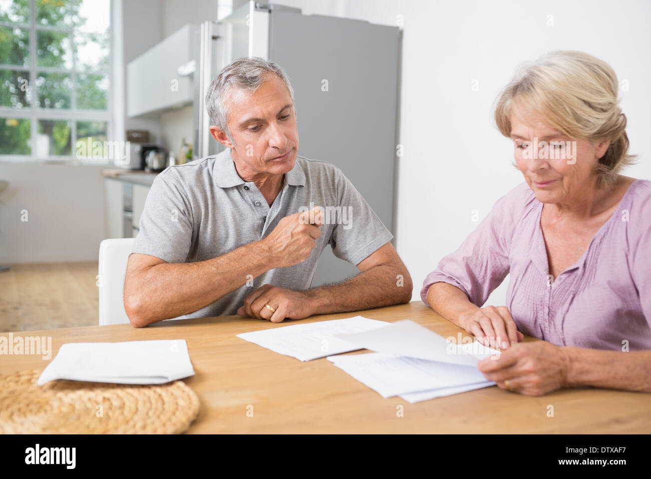 Couple reading documents together Stock Photo - Alamy