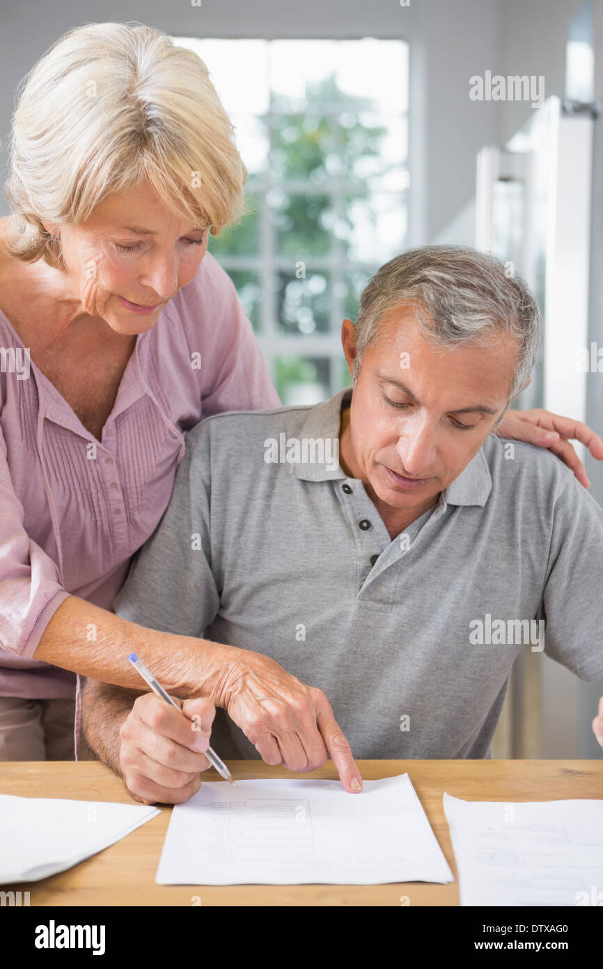 Wife showing where to sign Stock Photo - Alamy
