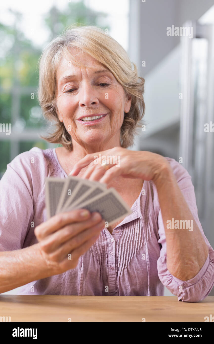 Happy woman playing cards Stock Photo - Alamy