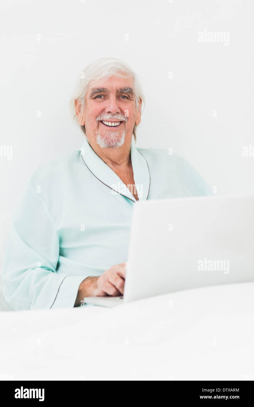 Smiling man in bed Stock Photo - Alamy