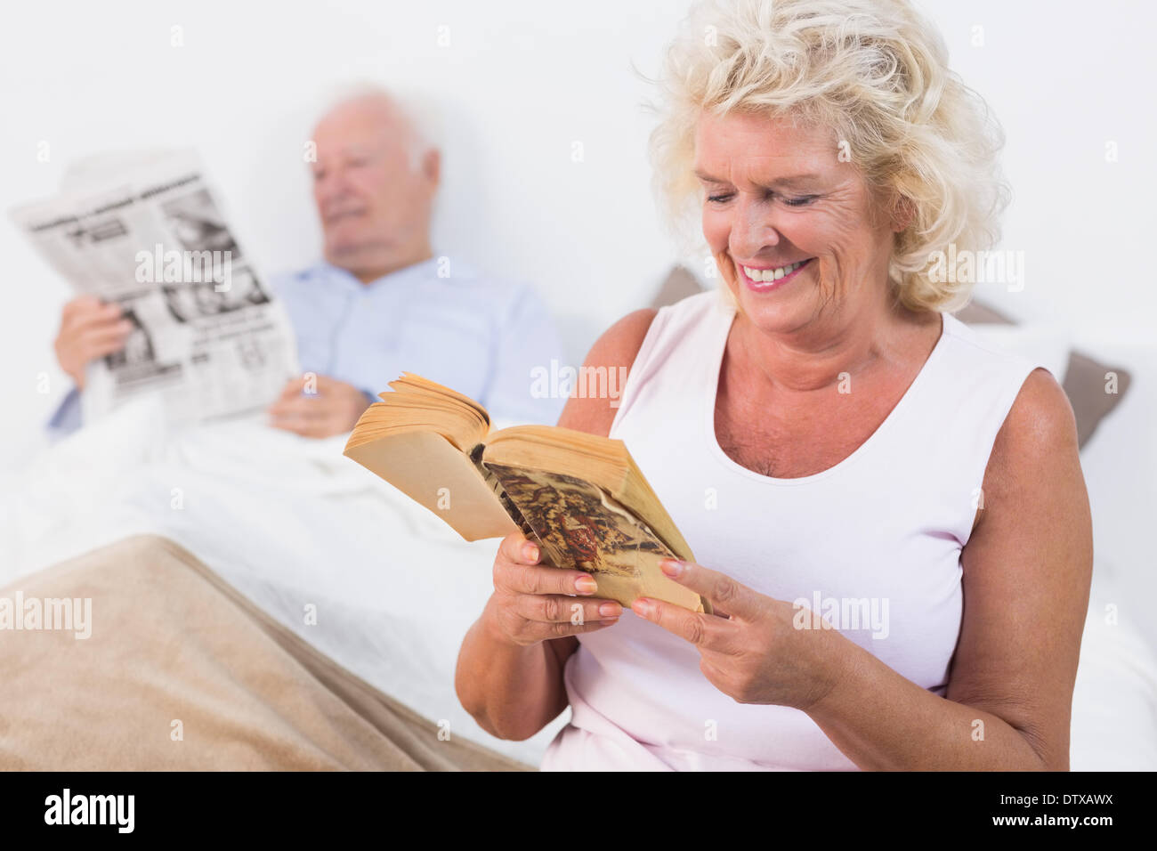 Old couple reading book and newspaper Stock Photo - Alamy