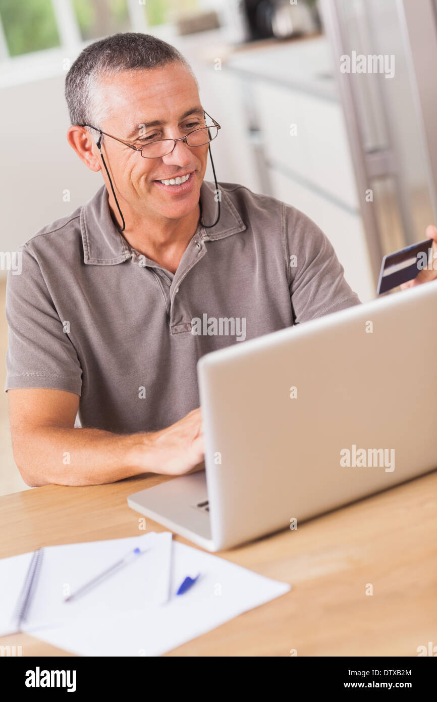 Man online shopping with laptop Stock Photo - Alamy